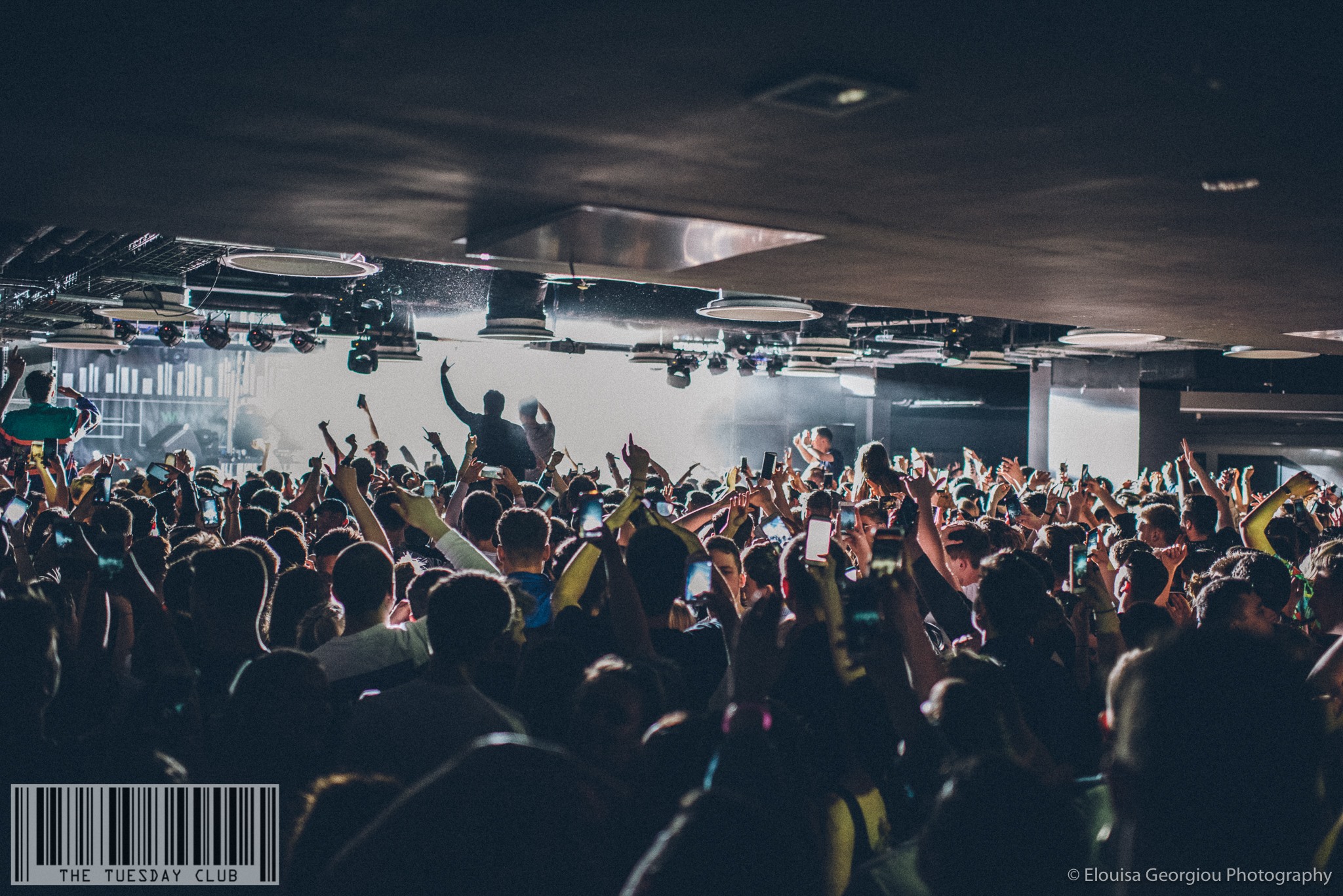 Student audience at a club night with bright lights